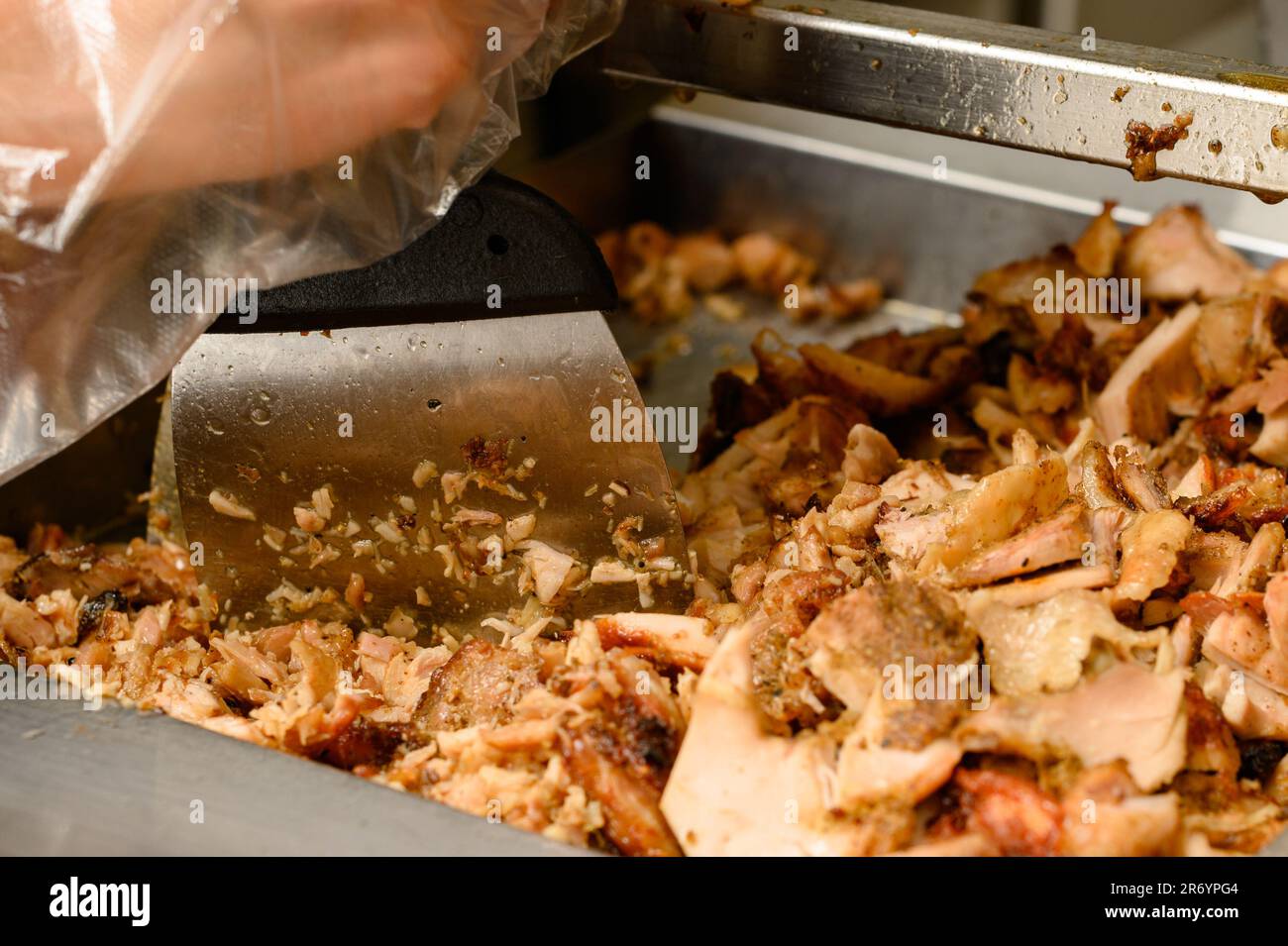 Shredding of meat in a fast food kitchen for shawarma, fried chicken ...