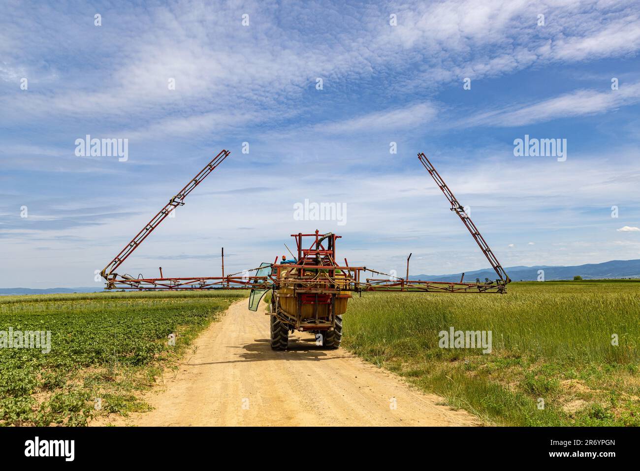 Tractor is moving along a rural road the end of agricultural work Stock ...