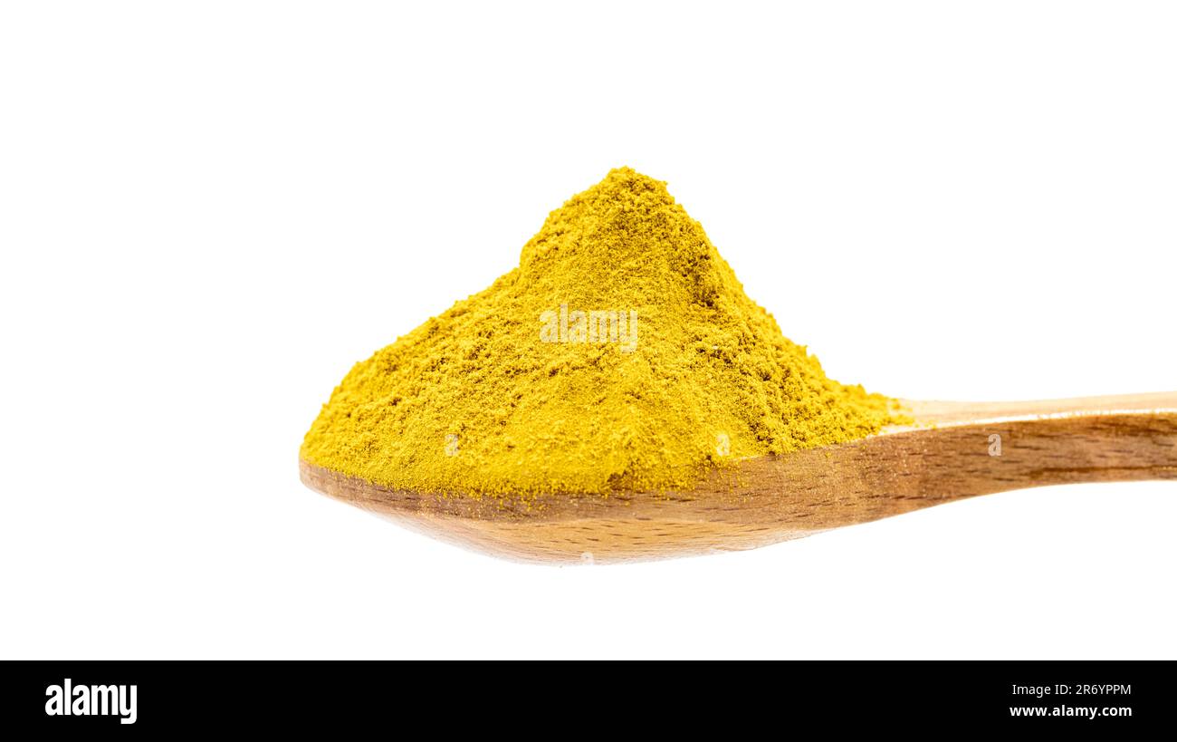 Powdered curry on wooden spoon. Pile of curry powder isolated on white ...