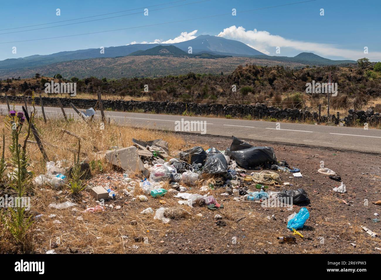 A heap of rubbish by the side of a country road in Sicily on the slopes ...
