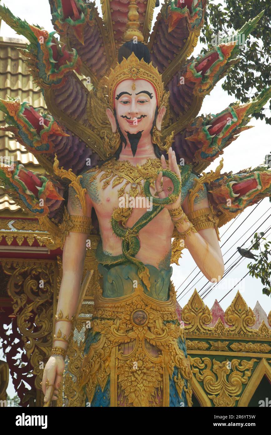 Statue of a standing angel with a serpent covering the back, guarding ...