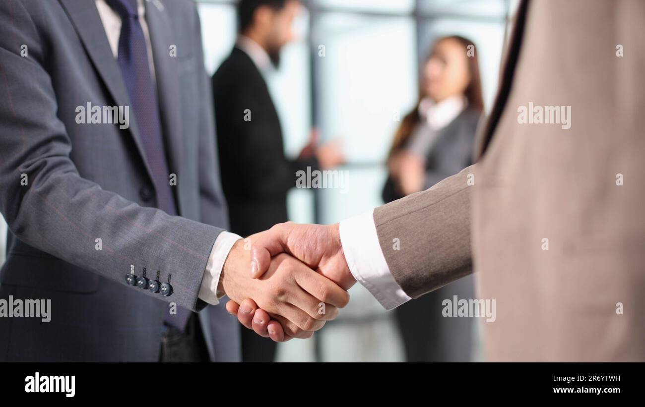 Business partners handshaking close hi-res stock photography and images ...