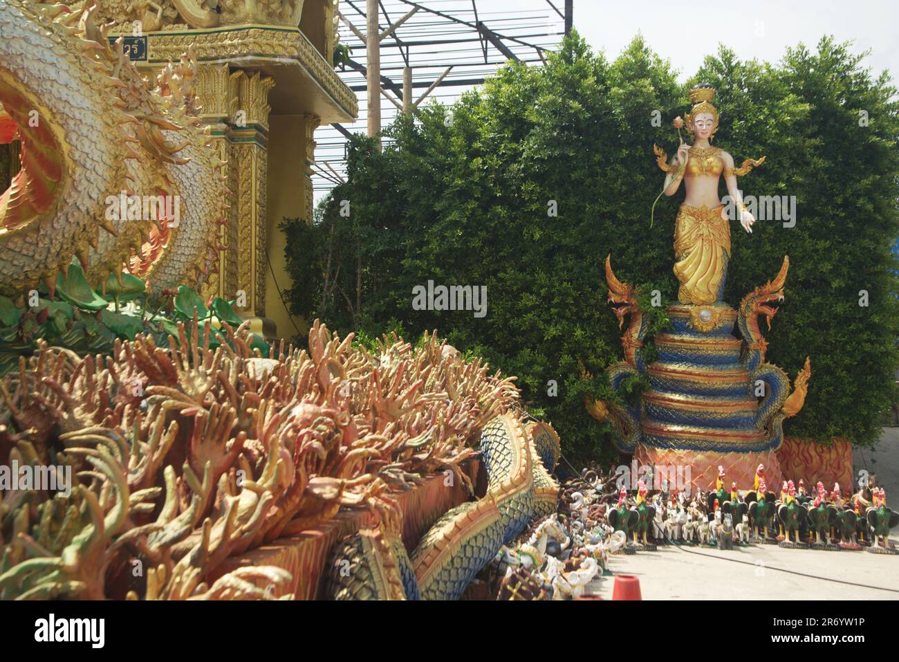 Statue of an angel holding lotus standing on a serpent to protect the ...