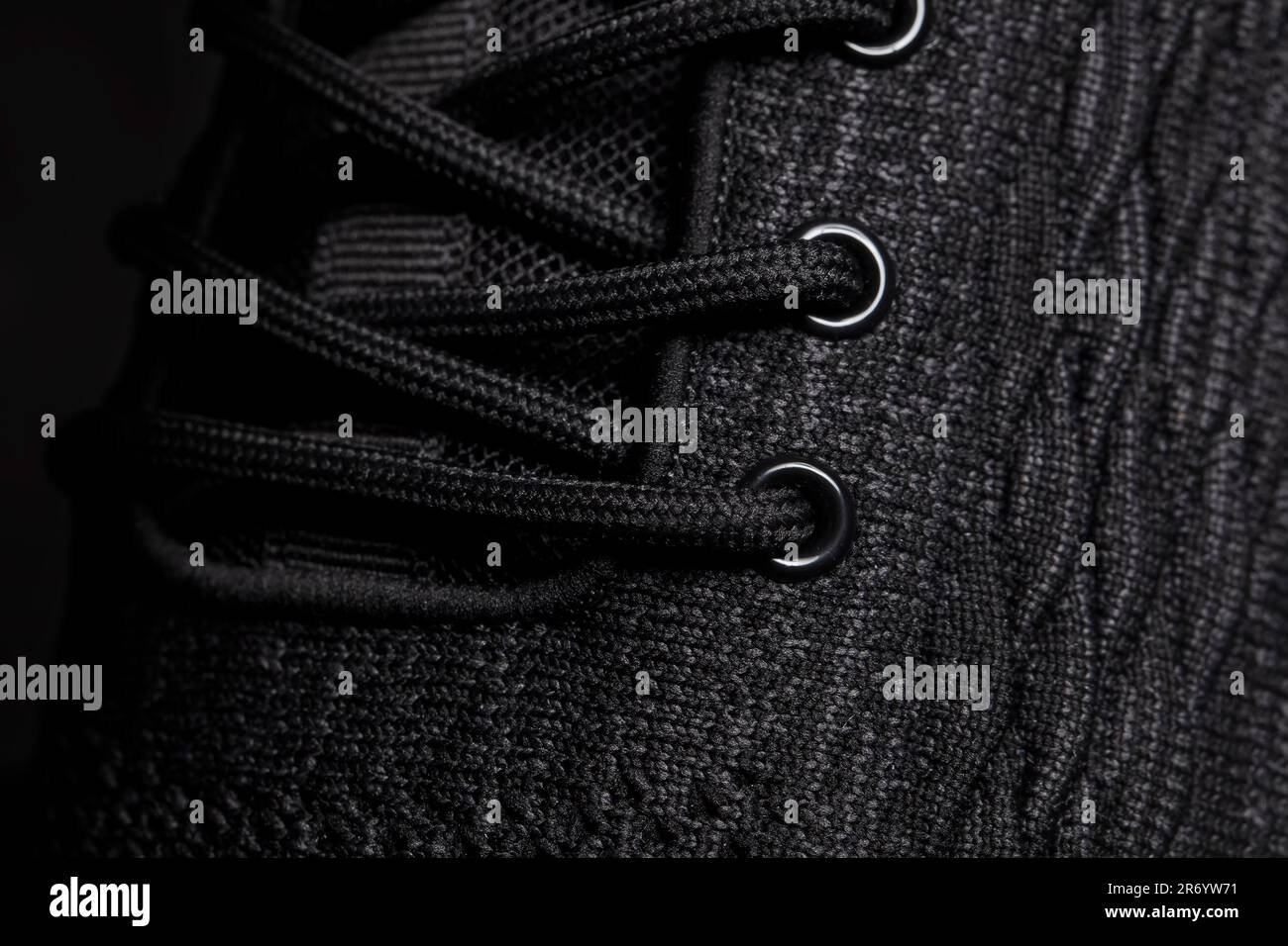The texture of a black rag sneaker with laces close-up Stock Photo - Alamy