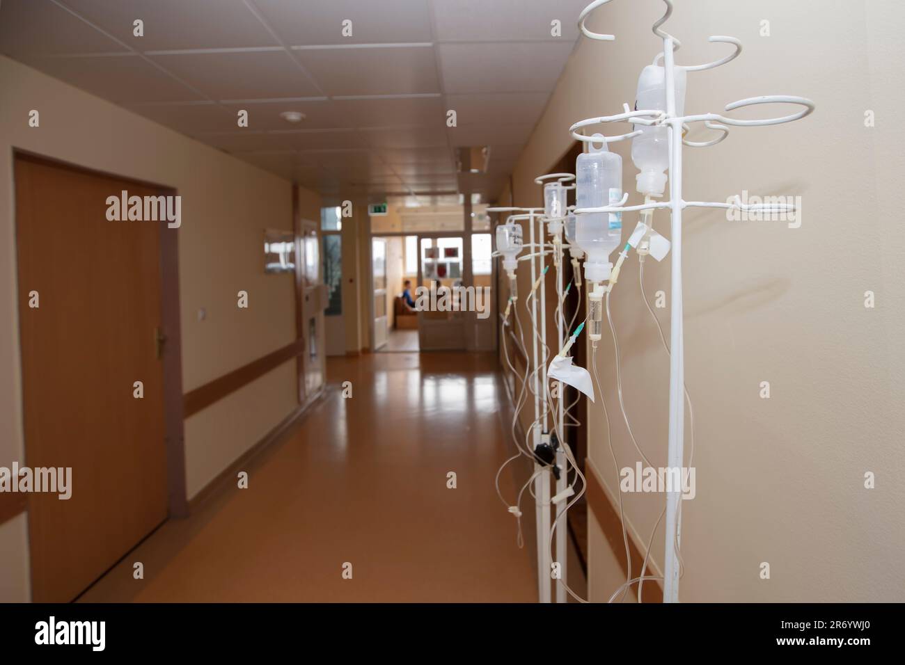 Medical droppers with saline solution in the corridor of the hospital ...