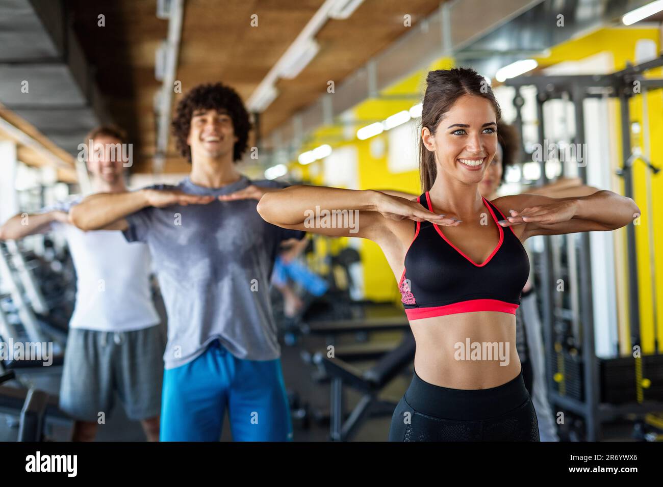 Group of fit people working out in a gym. Multiracial friends ...