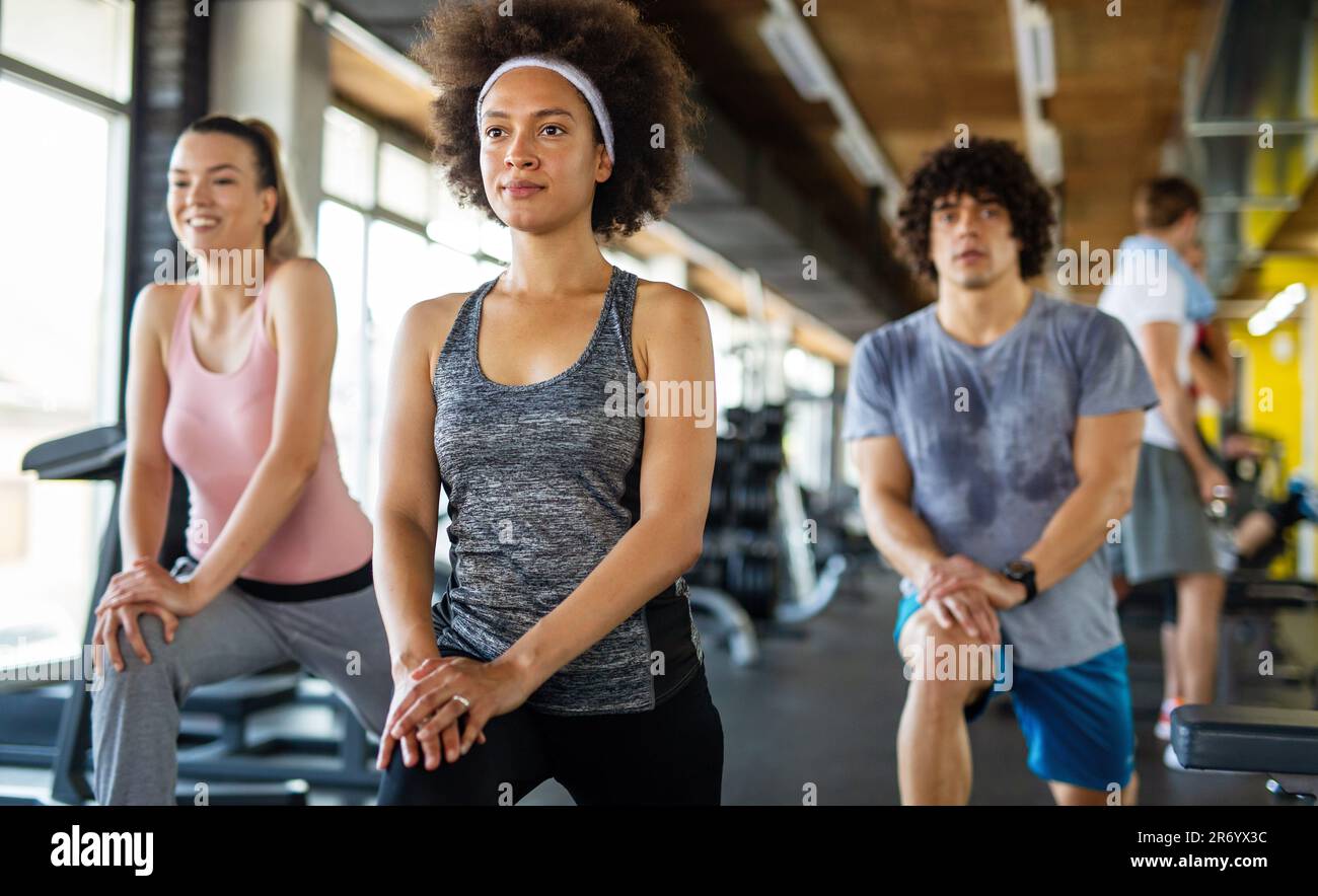Group of fit people working out in a gym. Multiracial friends ...