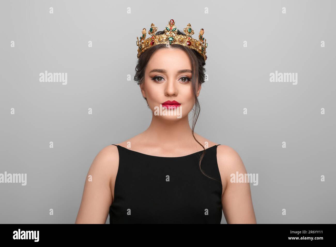 Beautiful young woman wearing luxurious crown on light grey background Stock Photo - Alamy