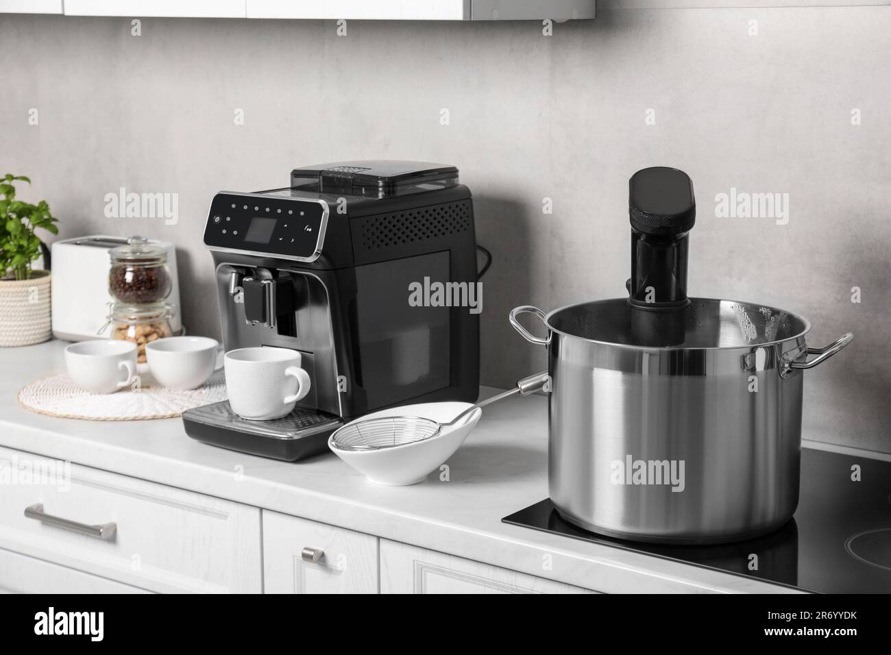 Pot with sous vide cooker in kitchen. Thermal immersion circulator ...