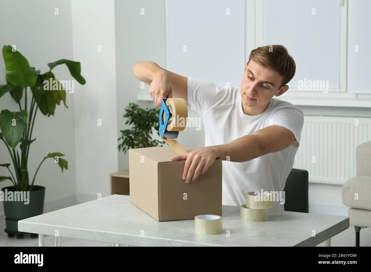 Handsome man packing box hi-res stock photography and images - Alamy