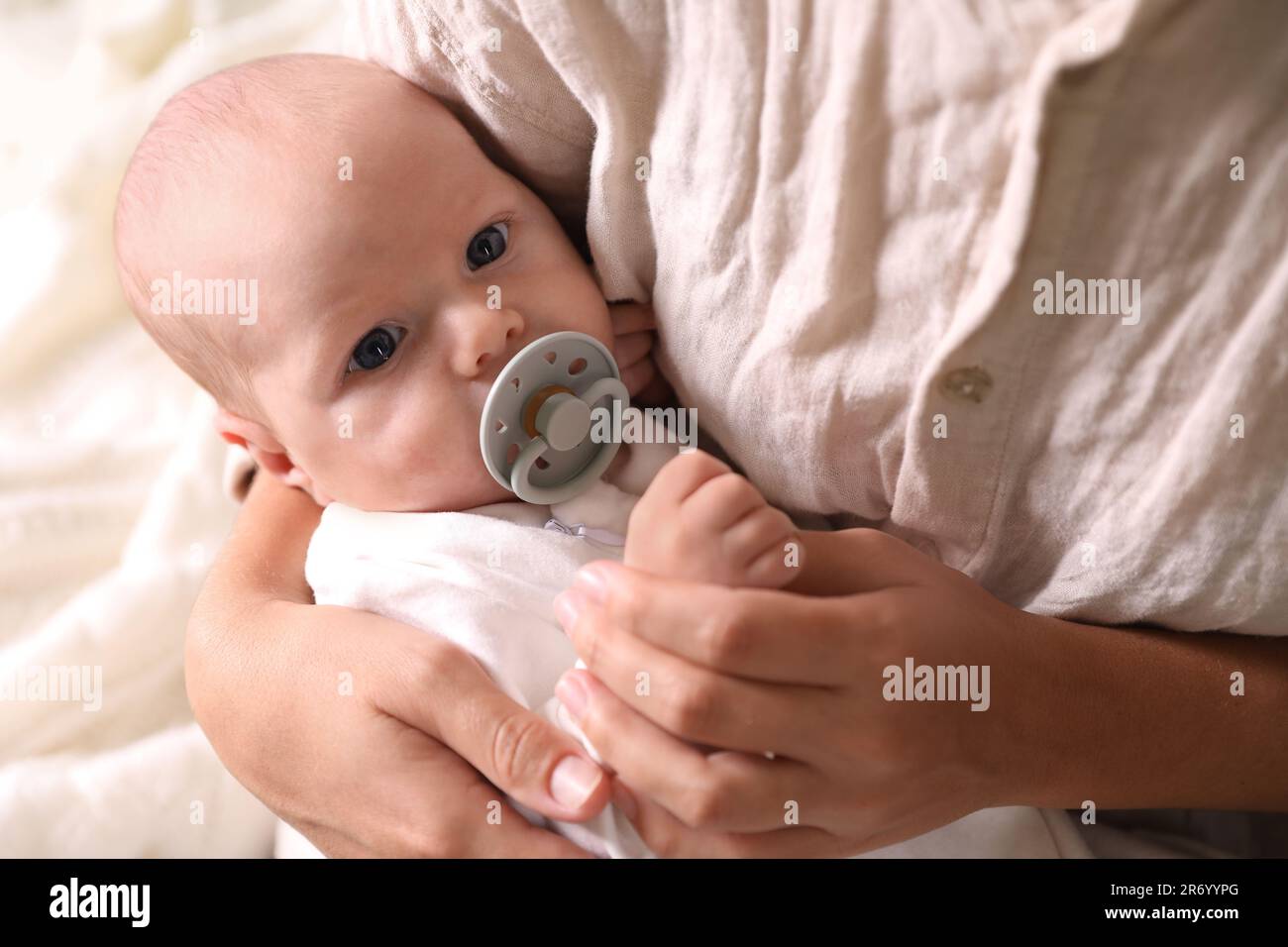 Mother hugging cute newborn baby on bed, closeup Stock Photo - Alamy