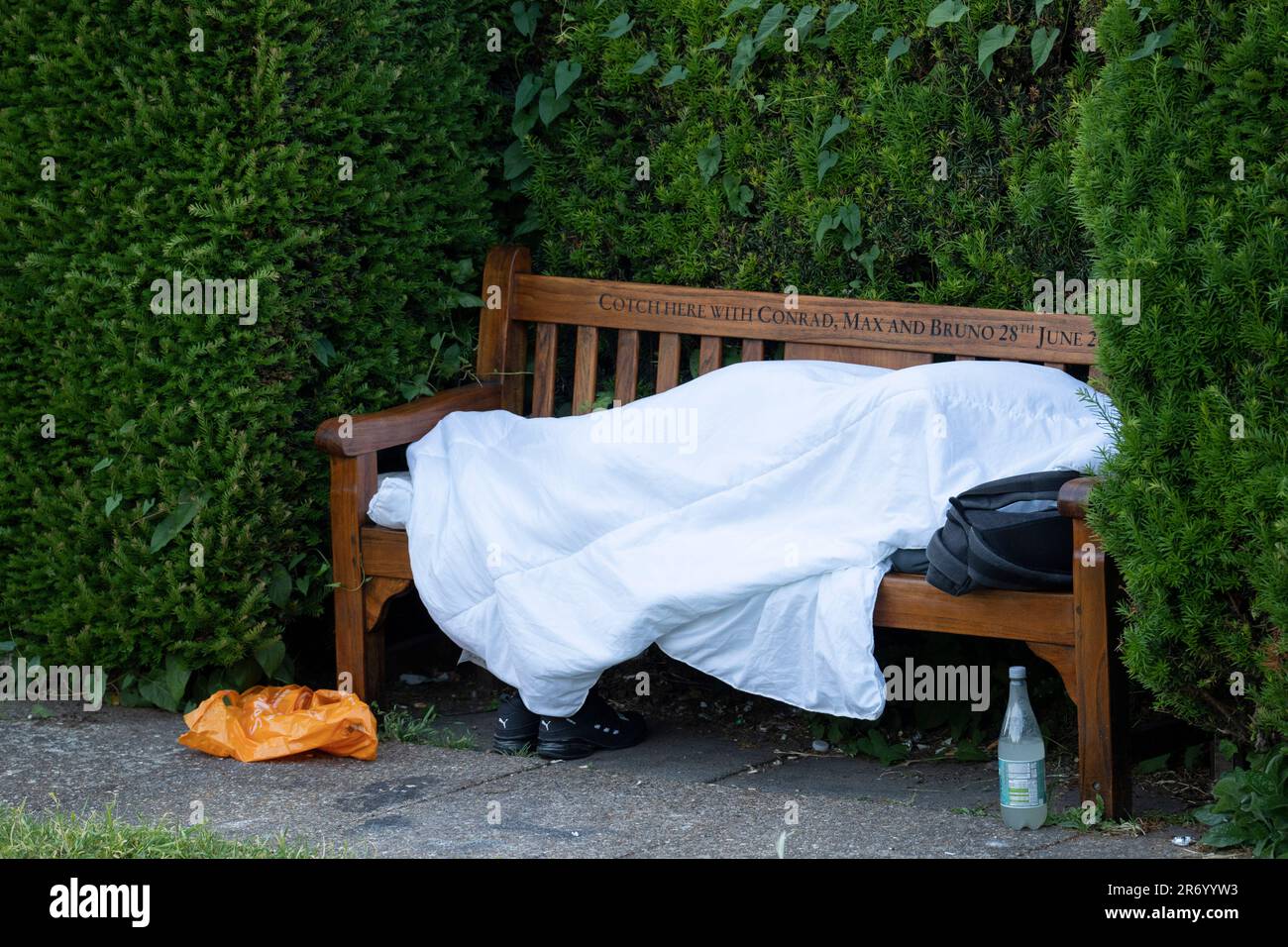 Early on a Sunday morning during the heatwave, a person sleeps ...