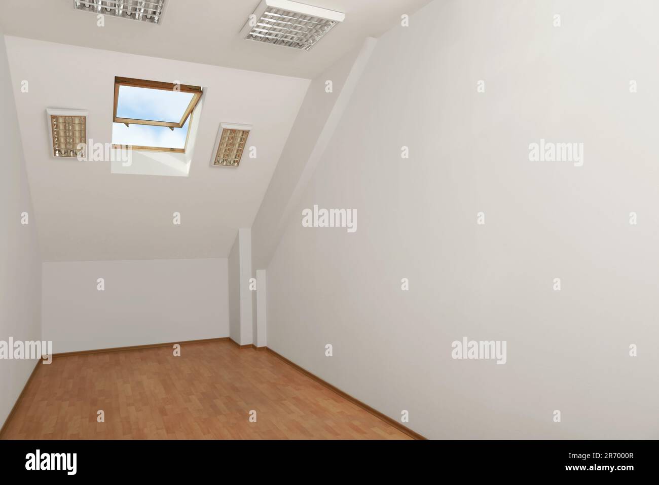 Light spacious attic room with roof window on slanted ceiling Stock ...