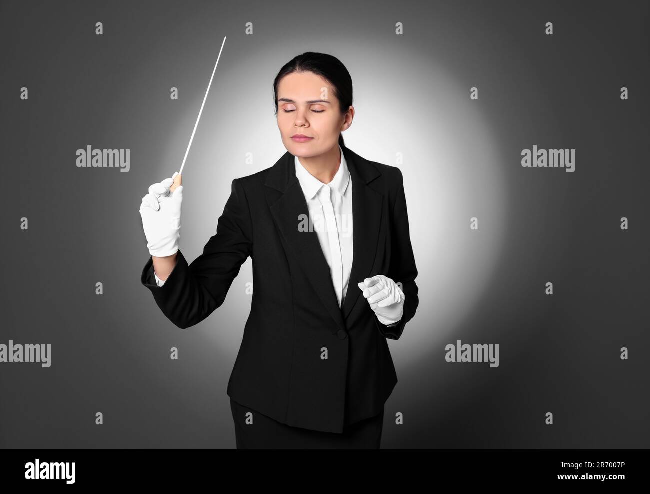 Professional conductor with baton on grey background Stock Photo - Alamy