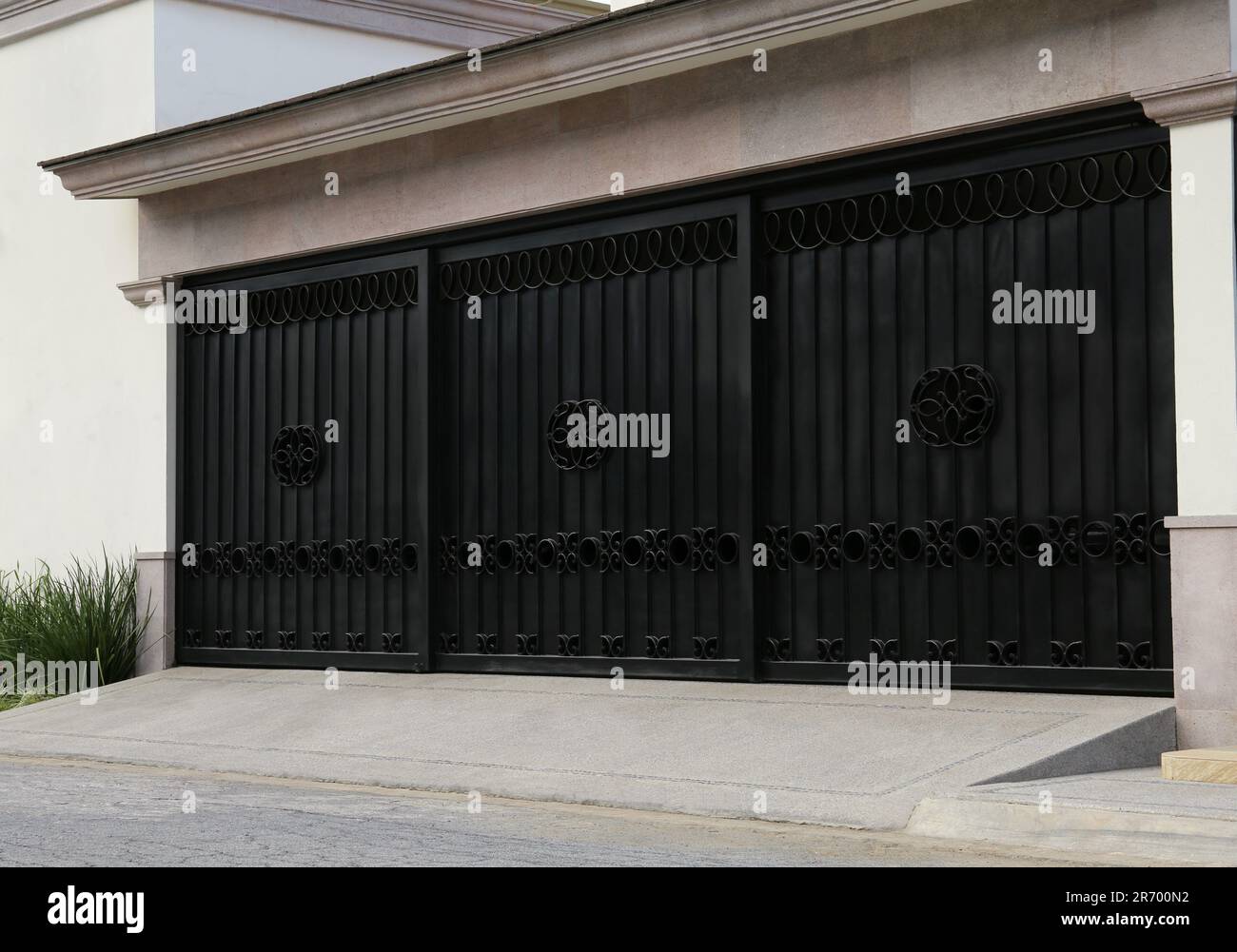 Closed metal gates of modern garage. Exterior design Stock Photo - Alamy