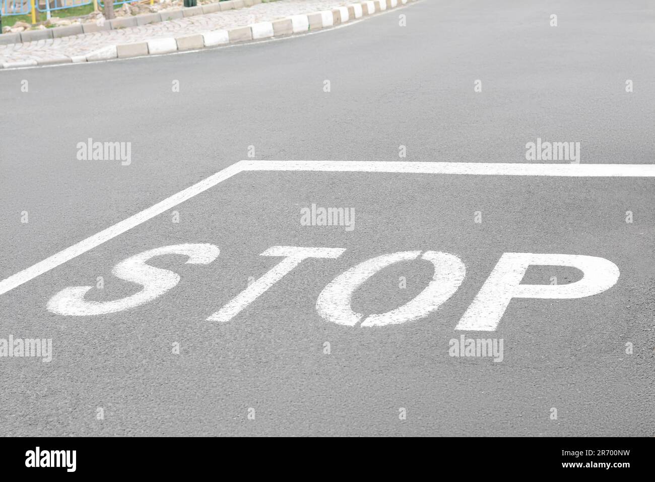 White sign Stop written on asphalt road in city Stock Photo - Alamy
