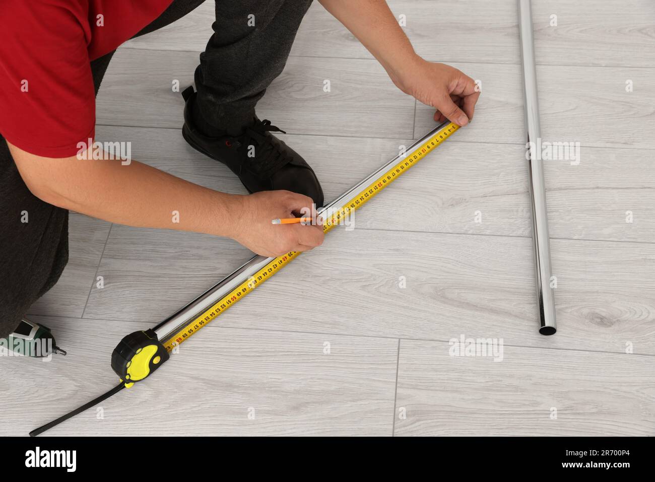 Worker measuring metal pipes for installation, closeup Stock Photo - Alamy