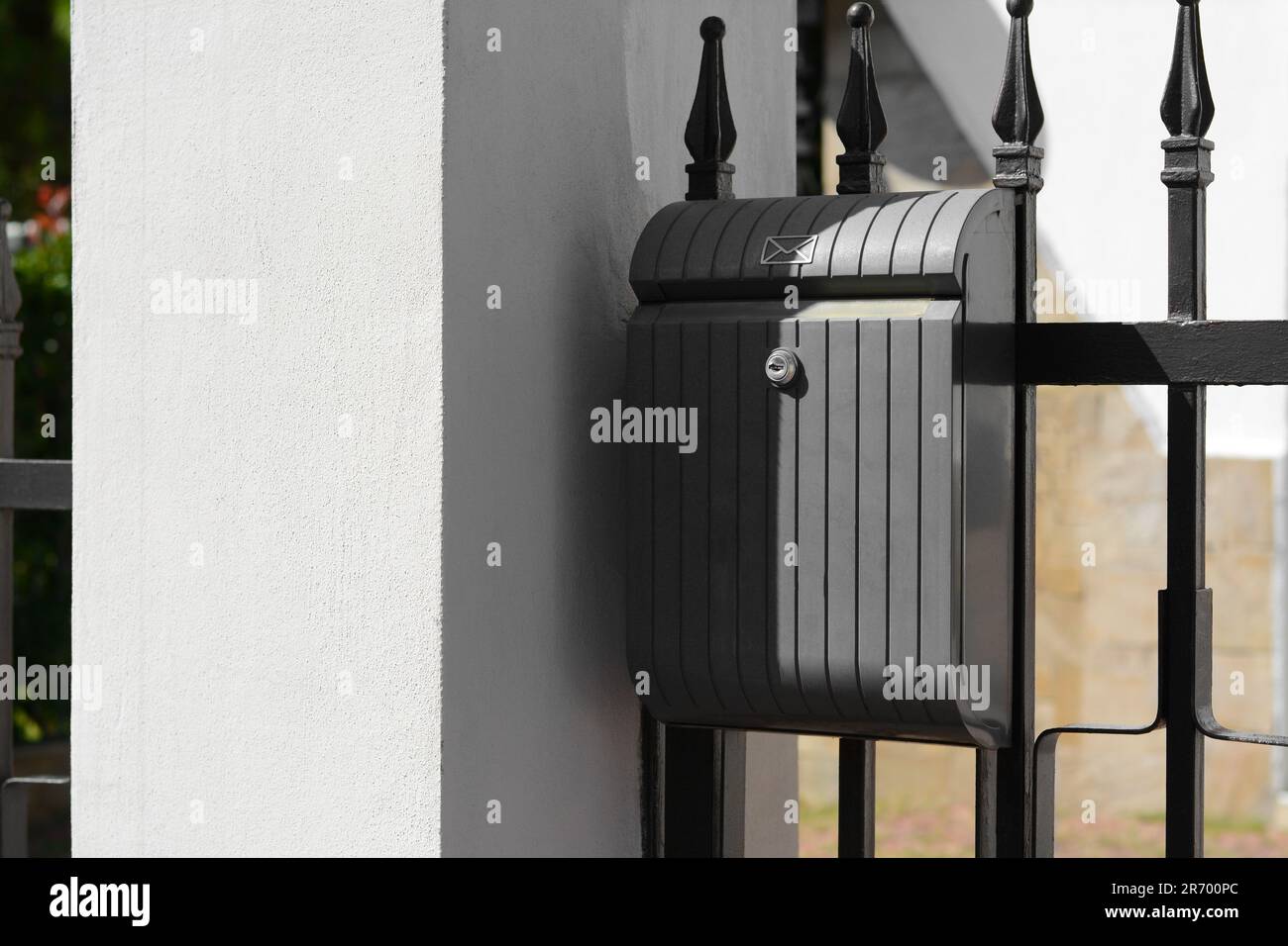 Dark metal letter box on fence outdoors Stock Photo - Alamy