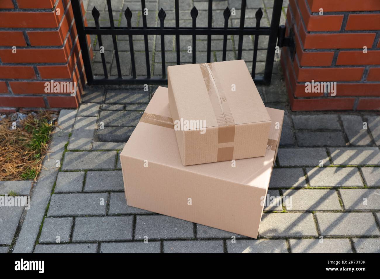 Stack of parcels delivered near front gates Stock Photo - Alamy