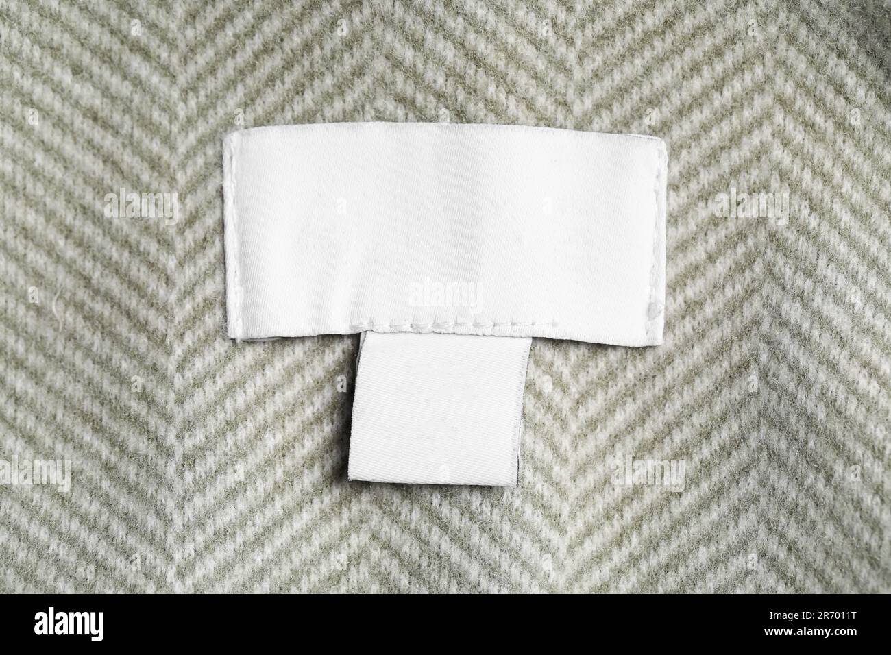 Clothing label on striped garment, top view Stock Photo - Alamy