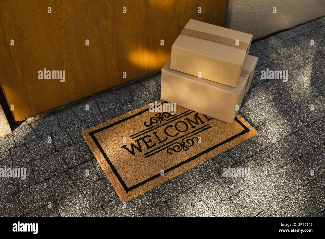 Stack of parcels delivered near front door Stock Photo - Alamy