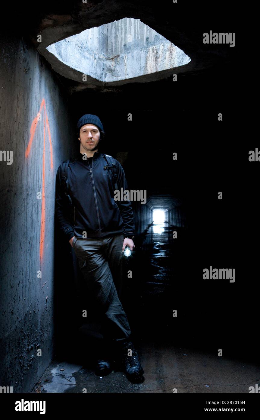 Author, Matthew O'Brien stands beneath an opening in a tunnel under the ...