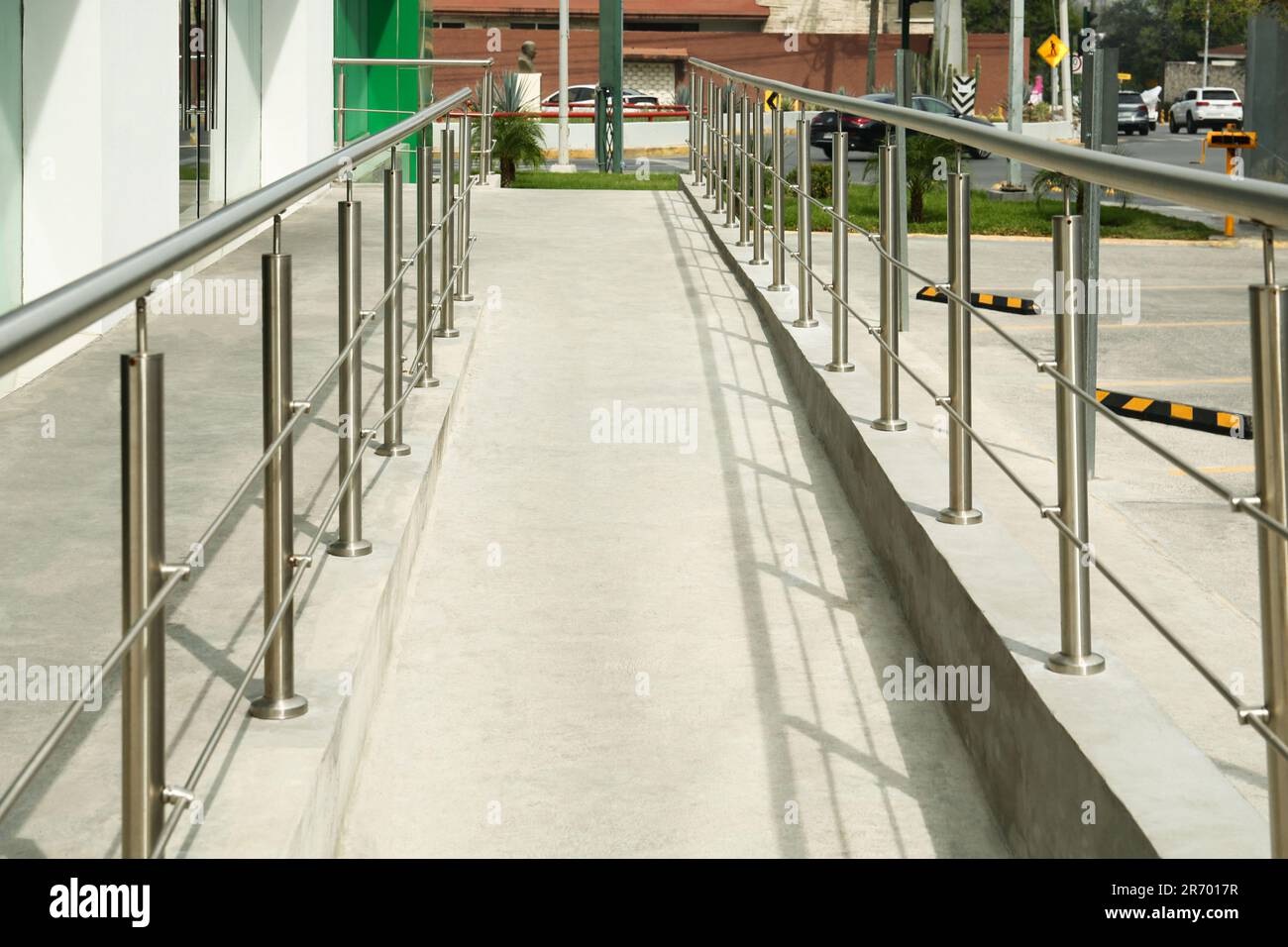 Concrete ramp with shiny metal railings outdoors Stock Photo - Alamy