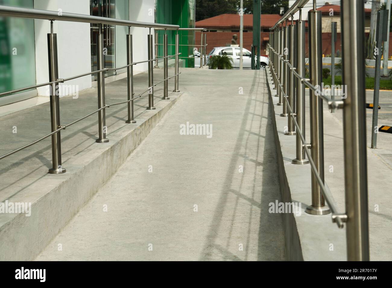 Concrete ramp with shiny metal railings outdoors Stock Photo - Alamy
