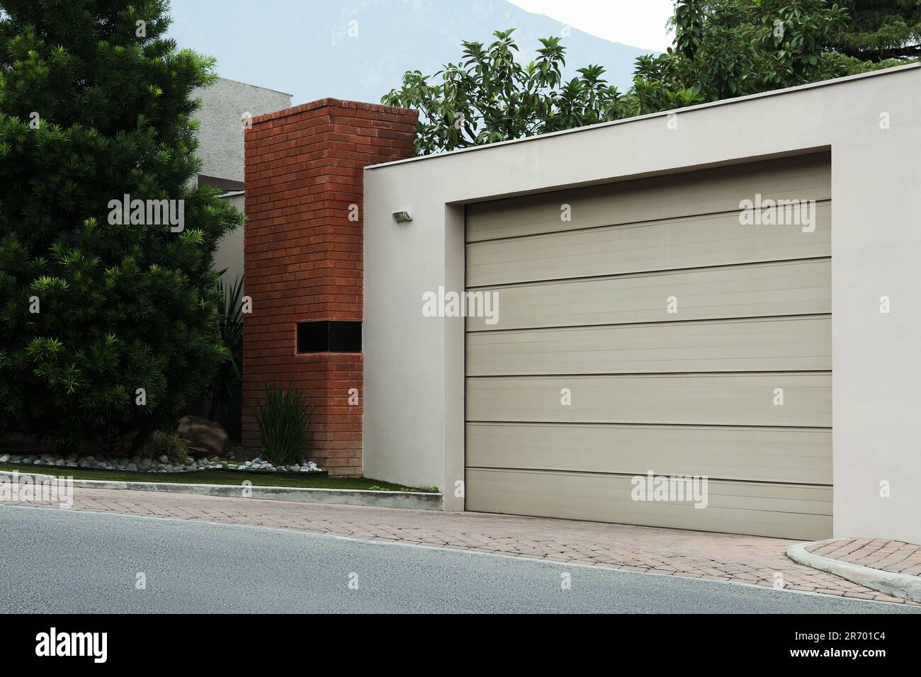 Beige garage with closed sectional door. Exterior design Stock Photo ...