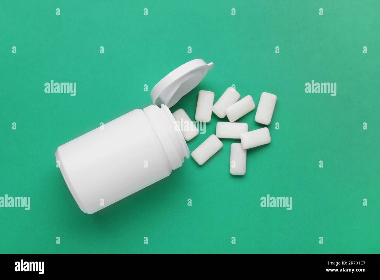 Jar with chewing gums on green background, flat lay Stock Photo - Alamy