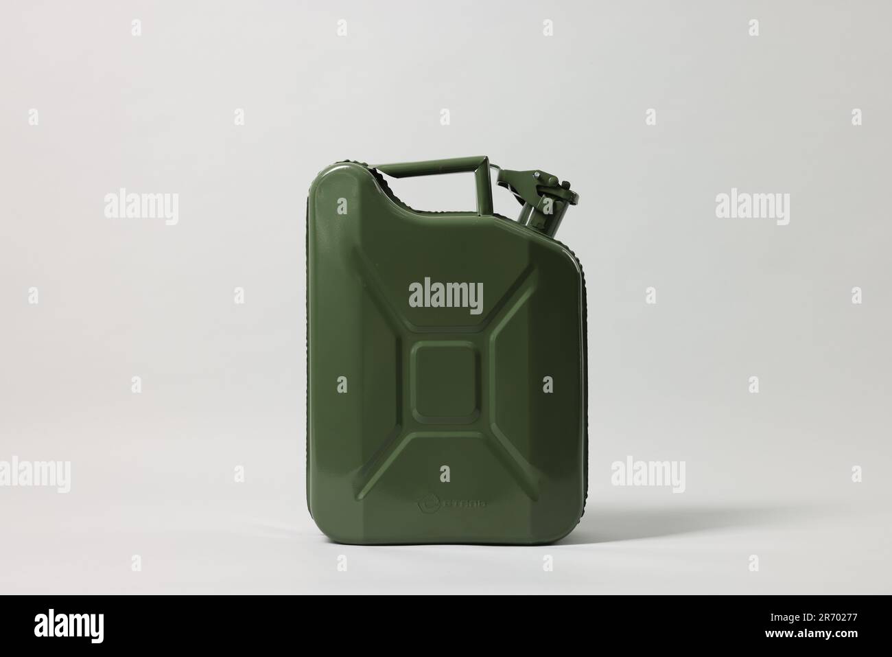 Green metal canister on light grey background Stock Photo - Alamy