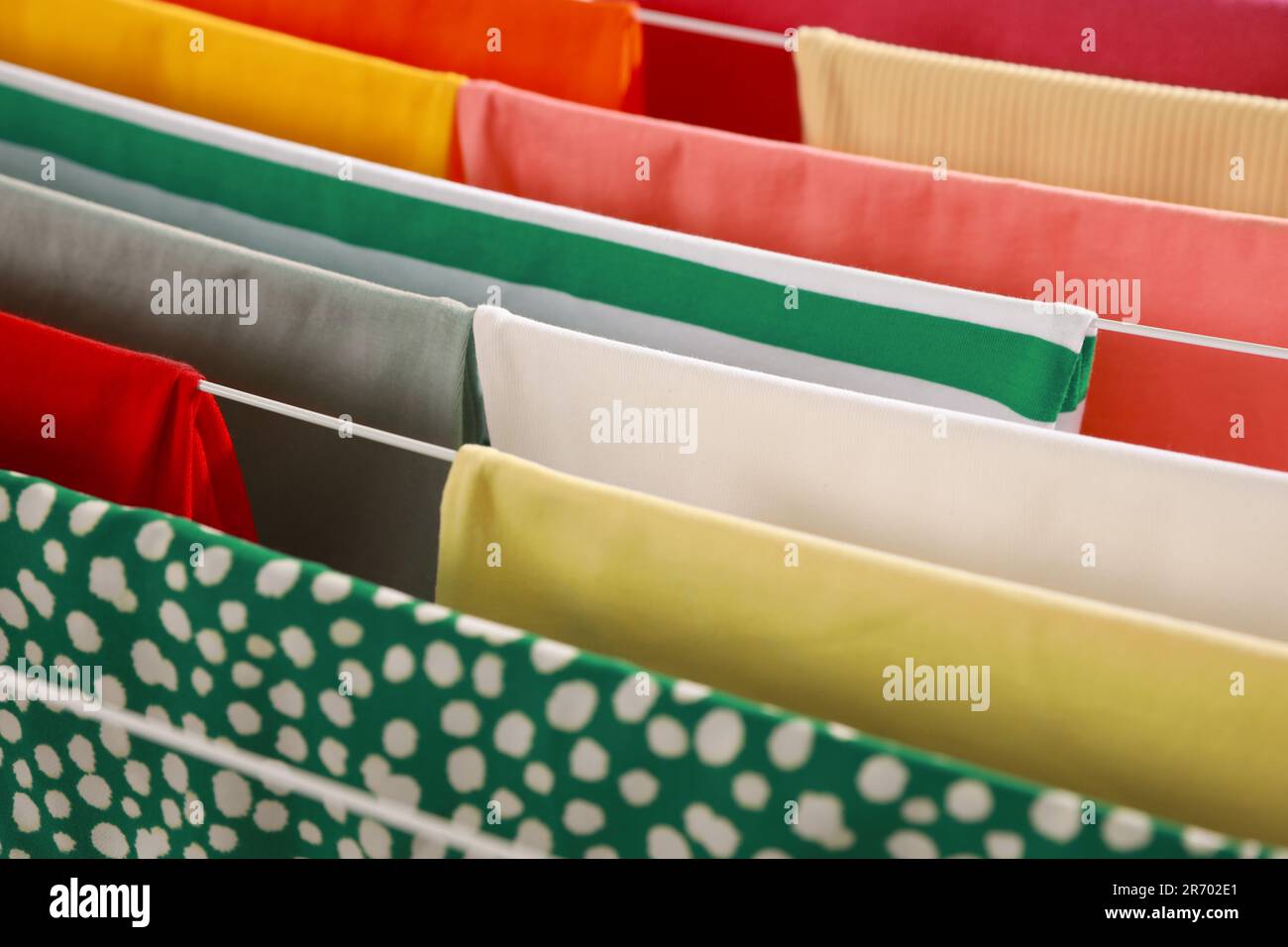 Different apparel drying on clothes airer, closeup Stock Photo - Alamy