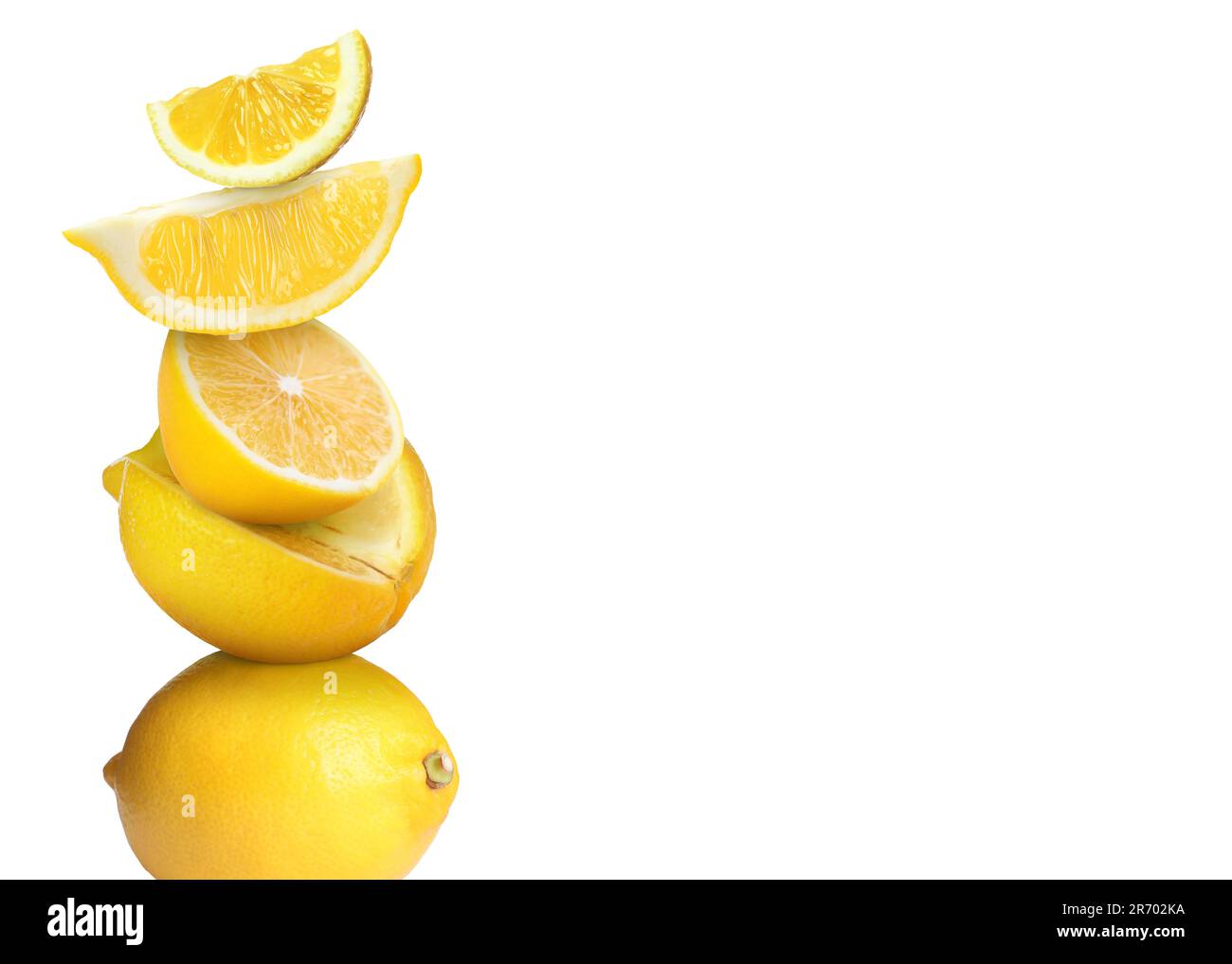 Stacked cut and whole lemons on white background Stock Photo - Alamy