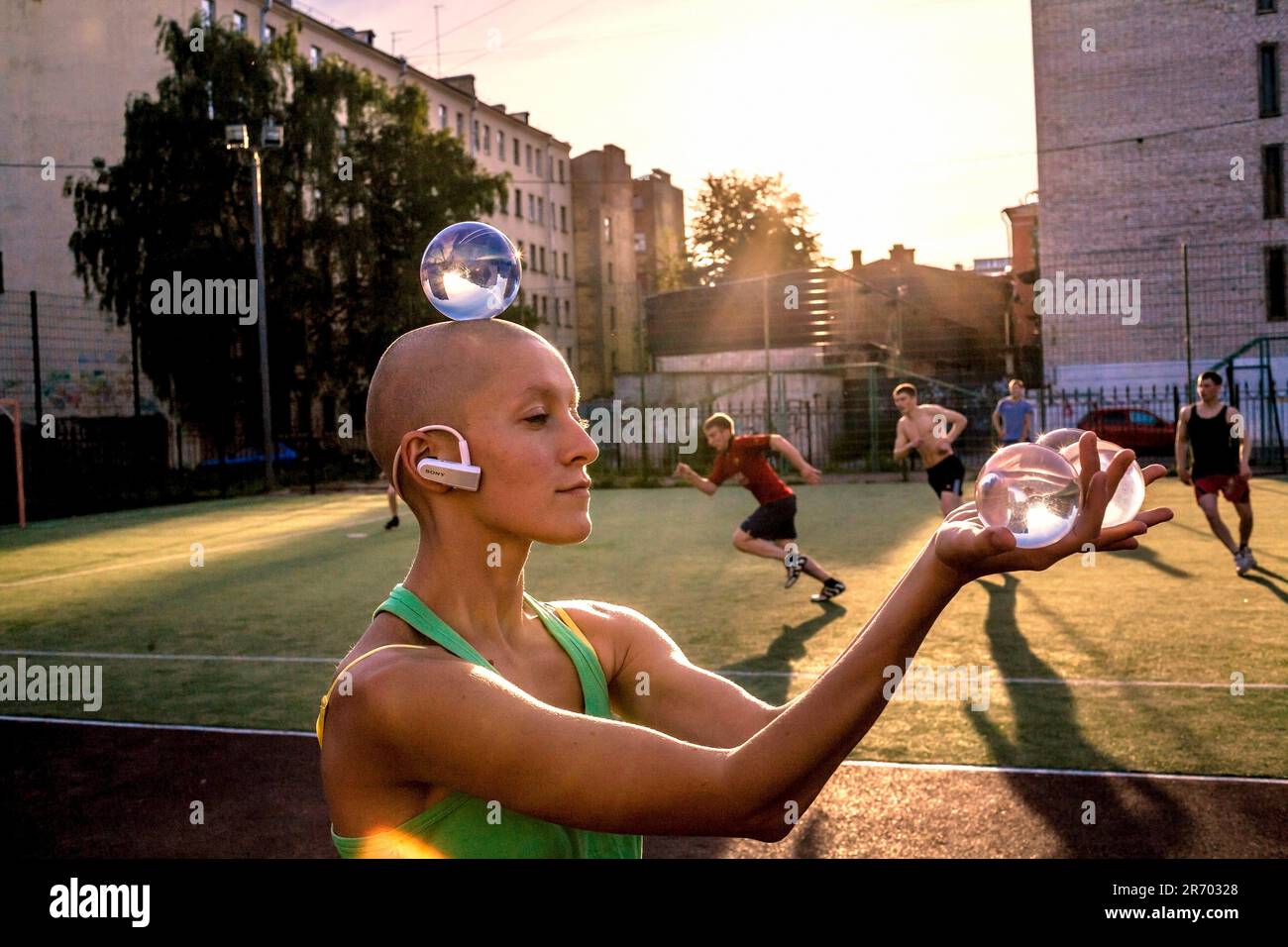 Bald Woman Juggling With Crystal Ball In The Park Stock Photo - Alamy
