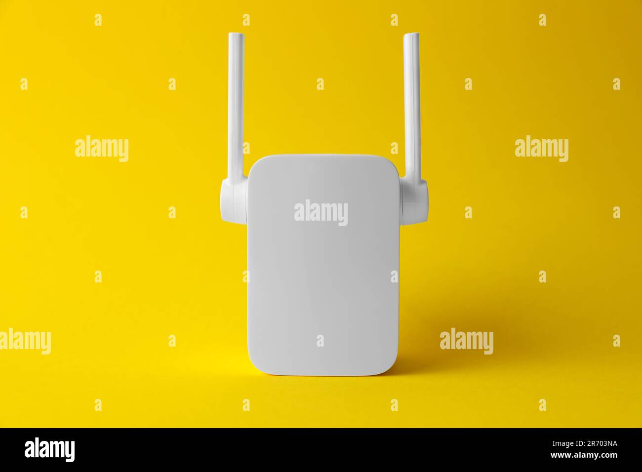 New modern Wi-Fi repeater on yellow background Stock Photo - Alamy