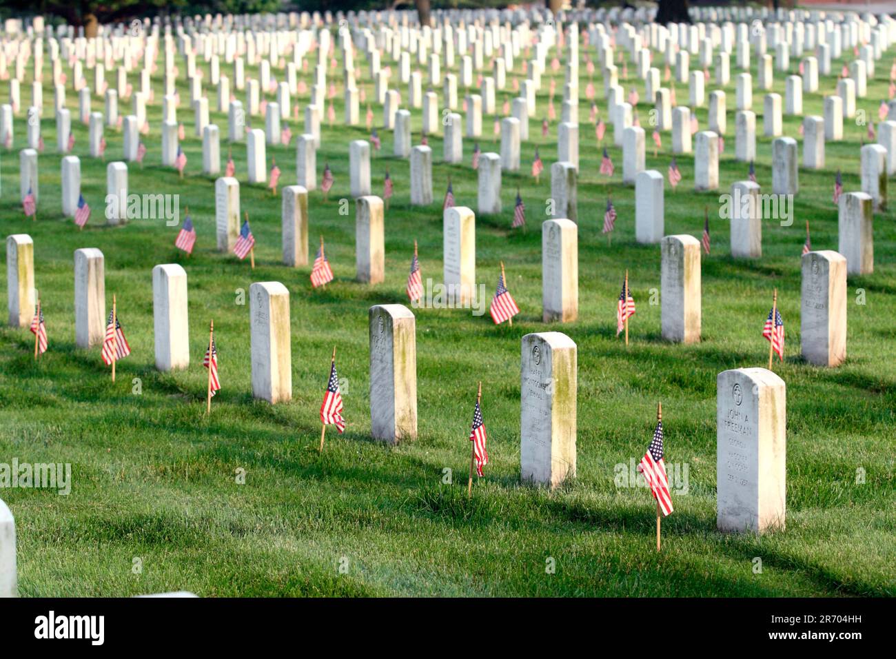 Soldiers place flags on graves at Arlington National Cemetery Stock ...