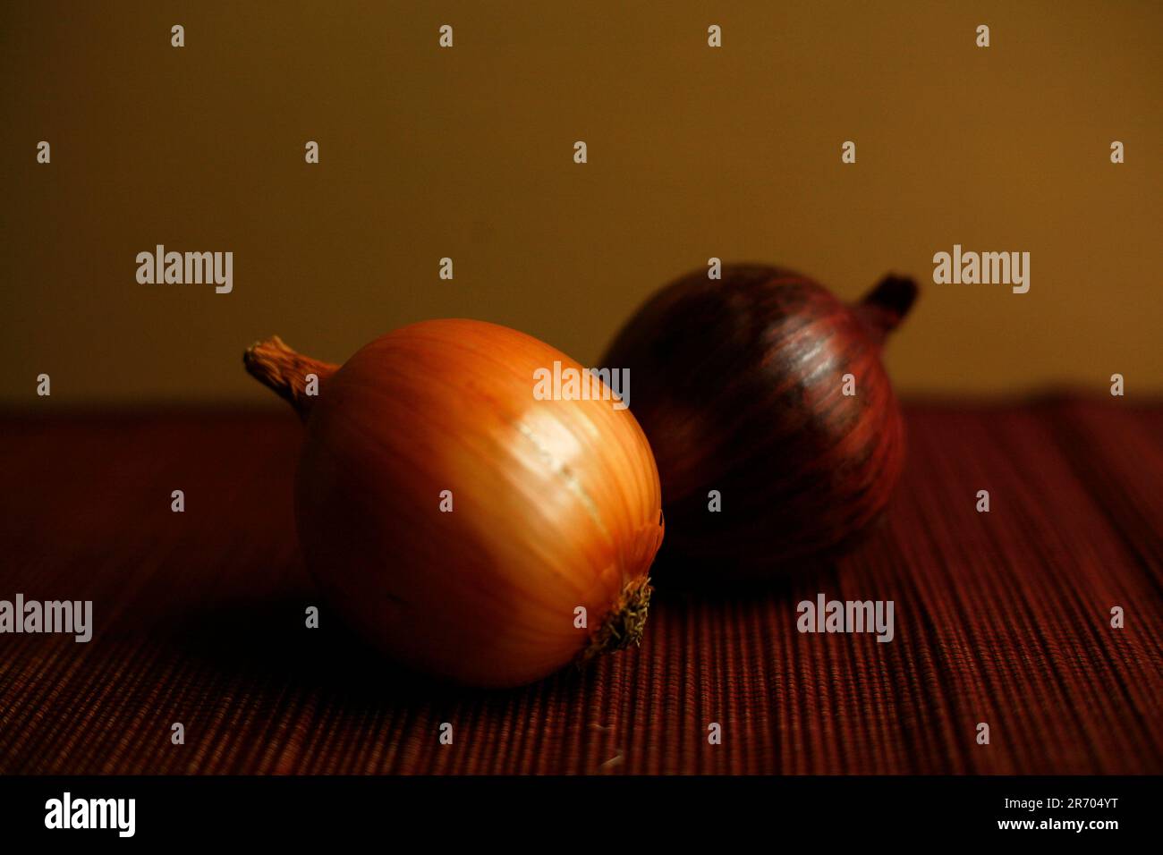 One red onion and one yellow onion with a neutral background Stock ...