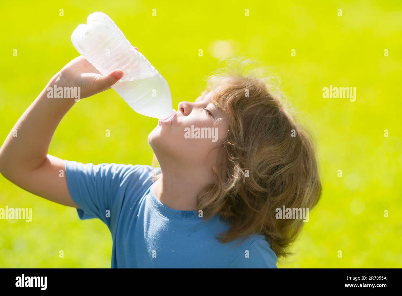 Kid drinking water. Portrait of happy smiling little child with glass ...