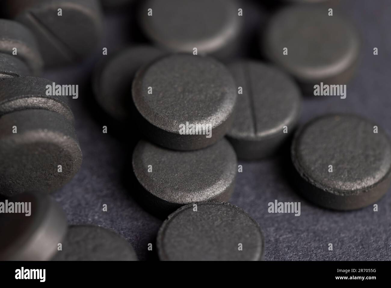 Open and unpacked tablets of black color close-up, several of the same ...