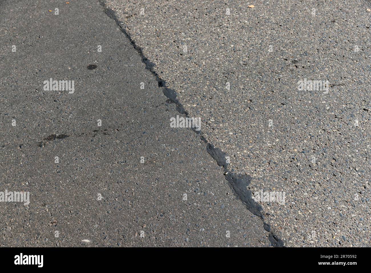 The repaired part of an asphalt road with patches, repair and ...