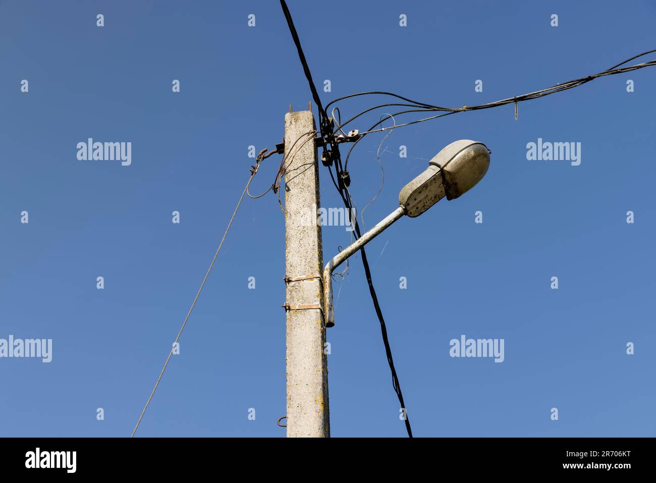 High-voltage power lines mounted on concrete poles, metal wires on ...