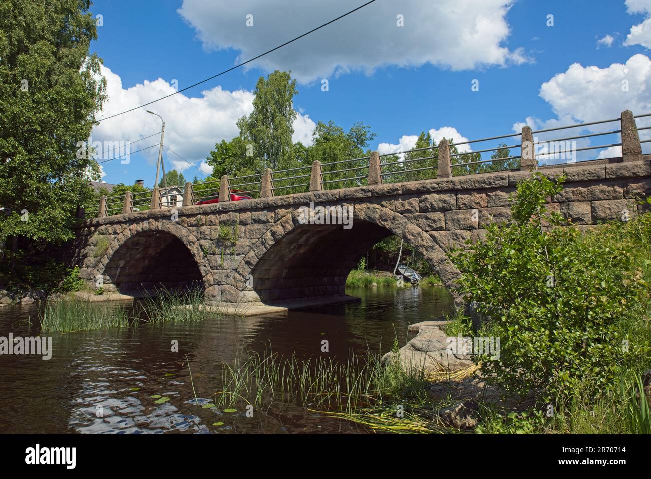 Self-supporting old stone bridge over river in summer Stock Photo - Alamy