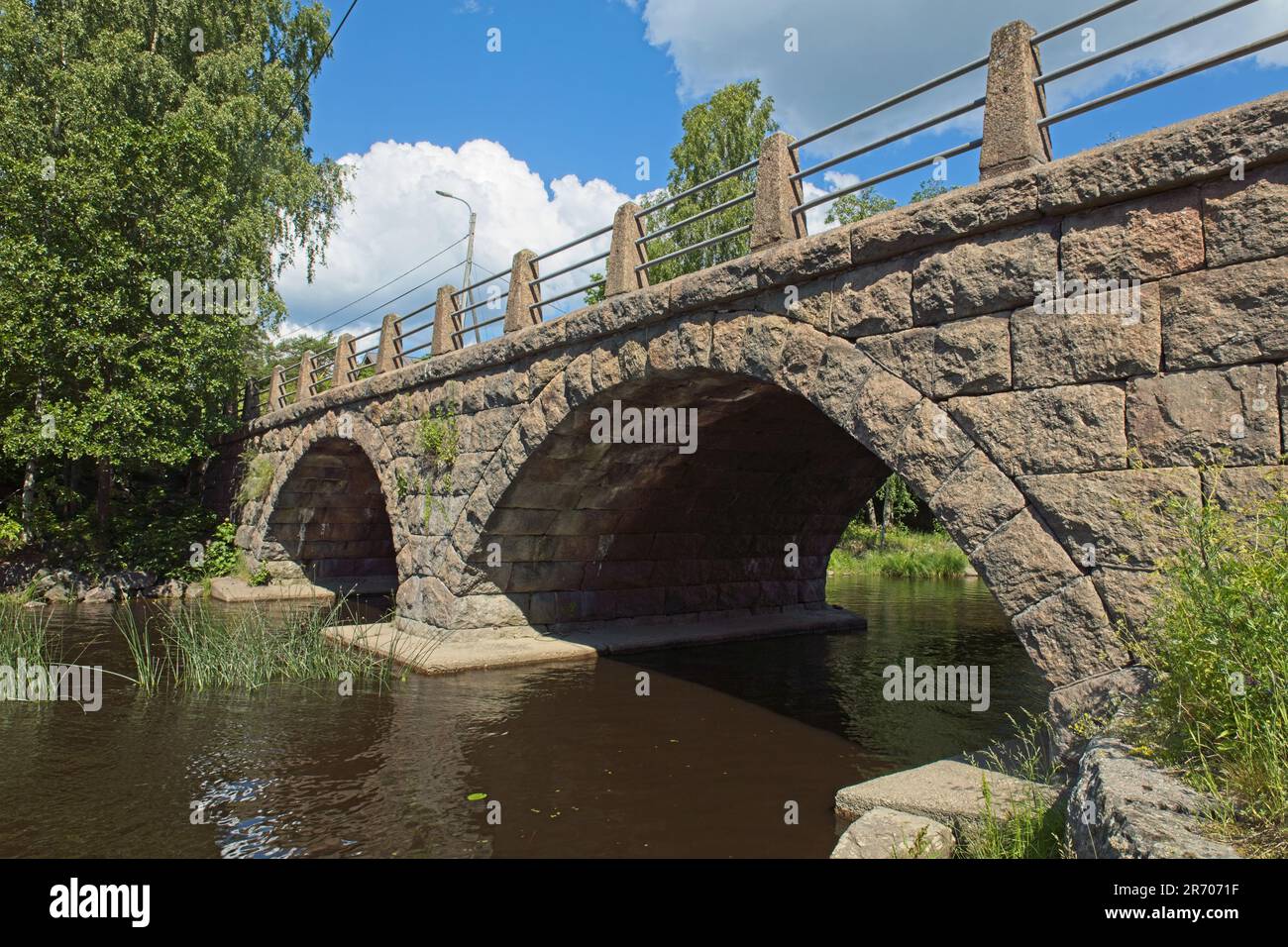 Self-supporting old stone bridge over river in summer Stock Photo - Alamy