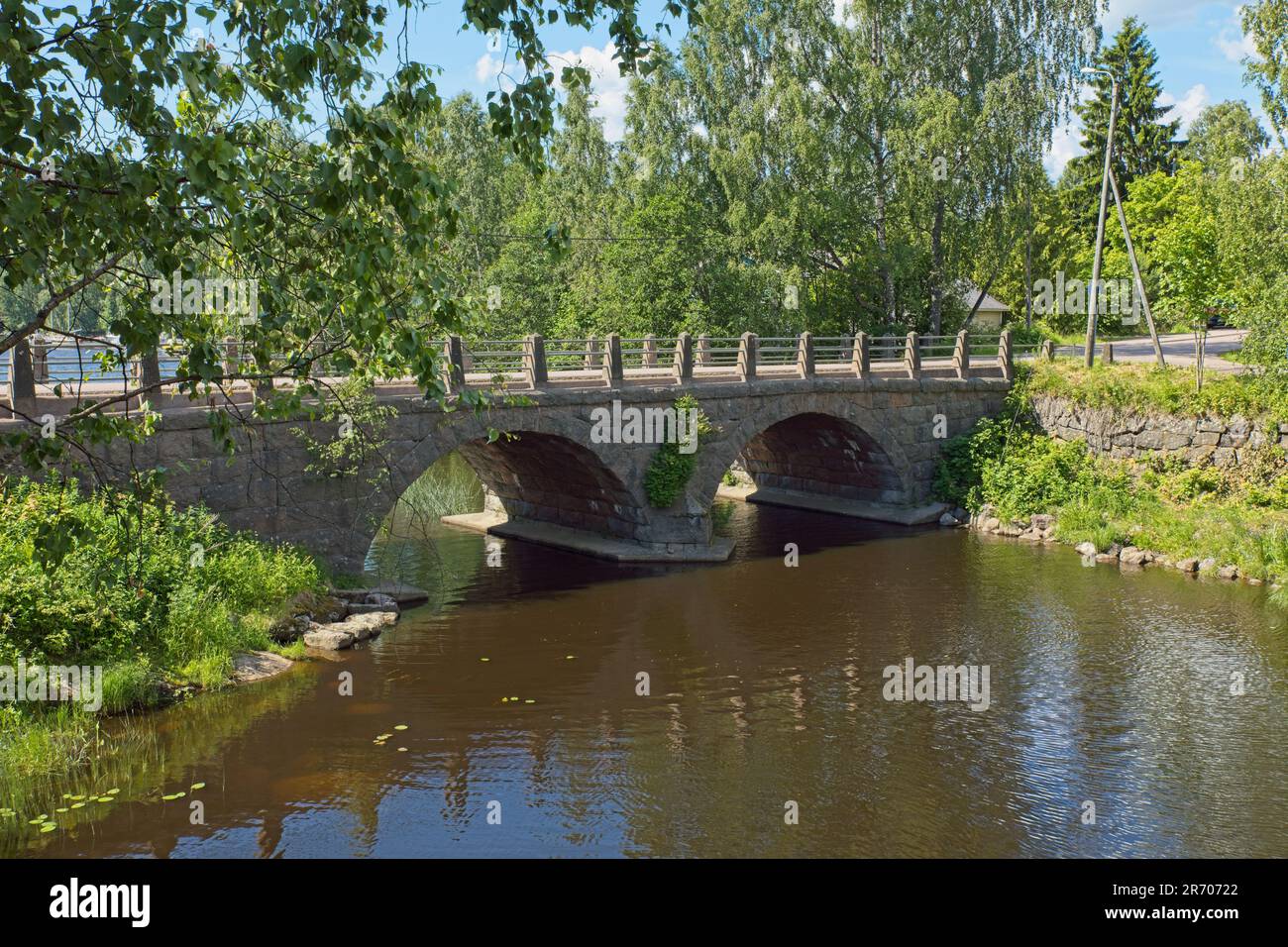 Self-supporting old stone bridge over river in summer Stock Photo - Alamy