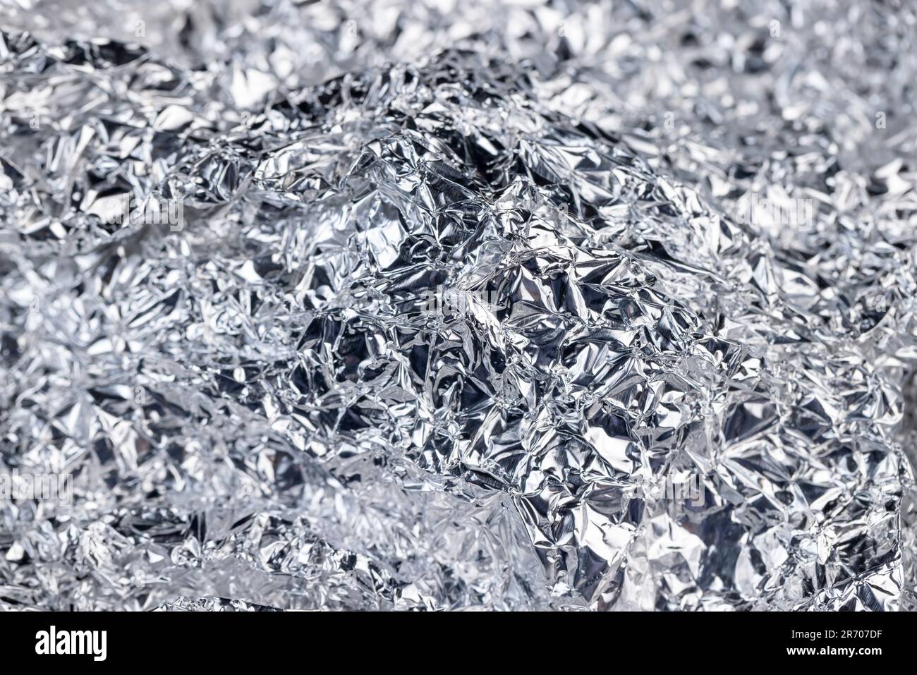 crumpled thin aluminum foil reflecting light, thin foil for use in ...