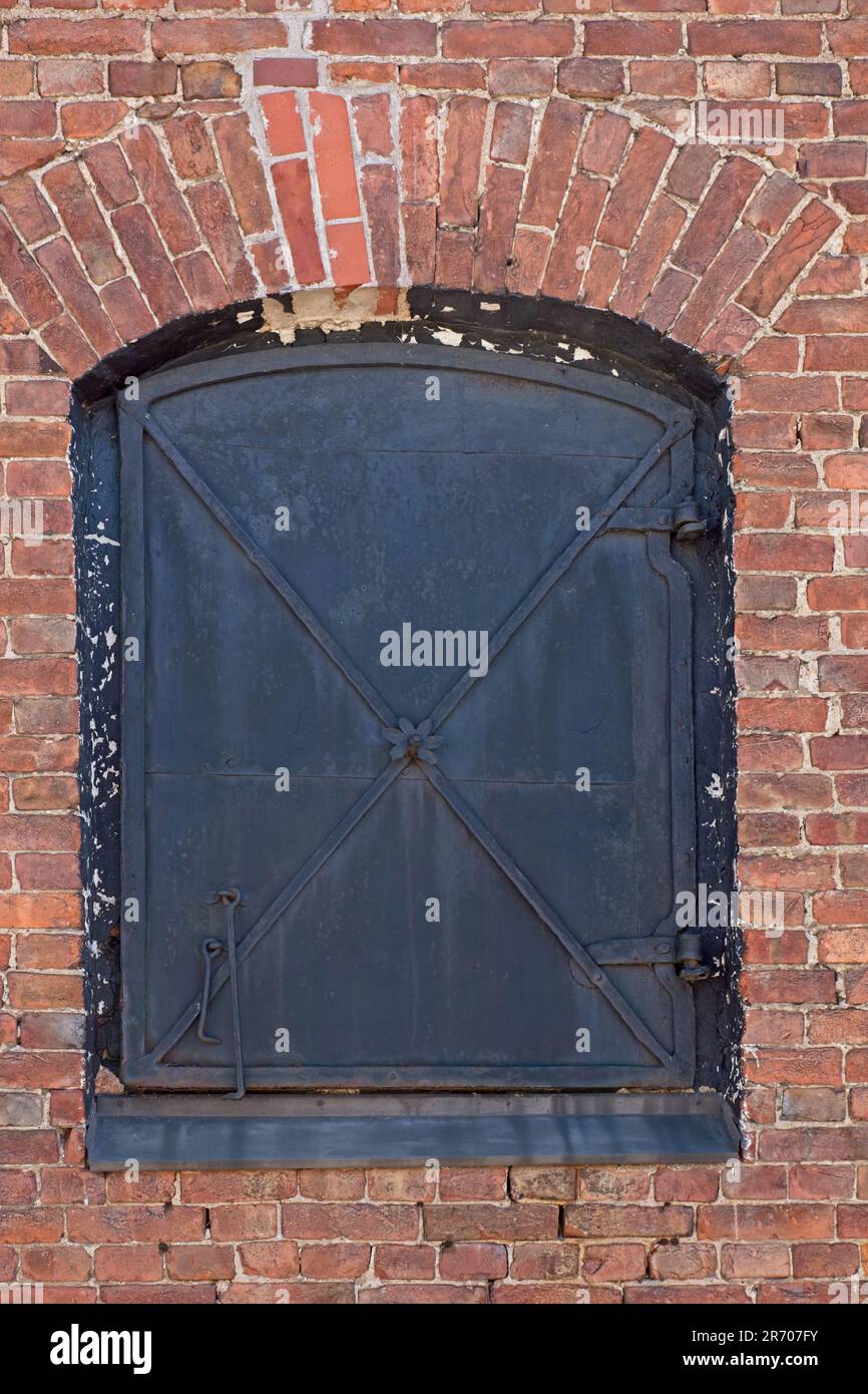 Closeup of old weathered metal hatch on a brick building Stock Photo ...
