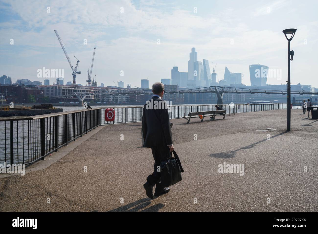 London UK. 12 June 2023 . A pedestrian walking on a hot humid morning ...