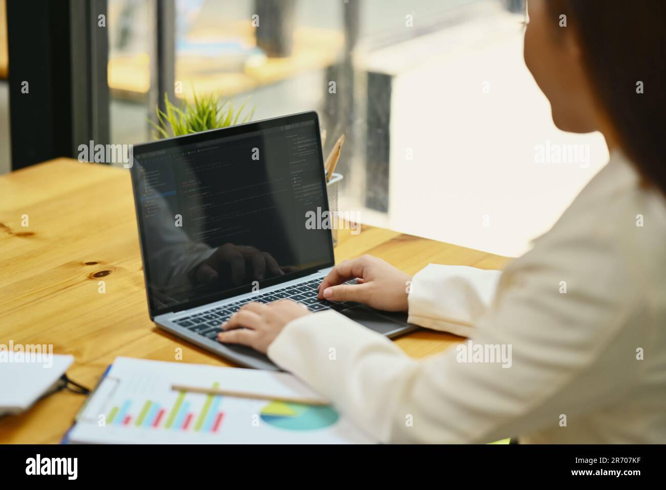 Side View Of Female Developer Working With Coded Data On Computer