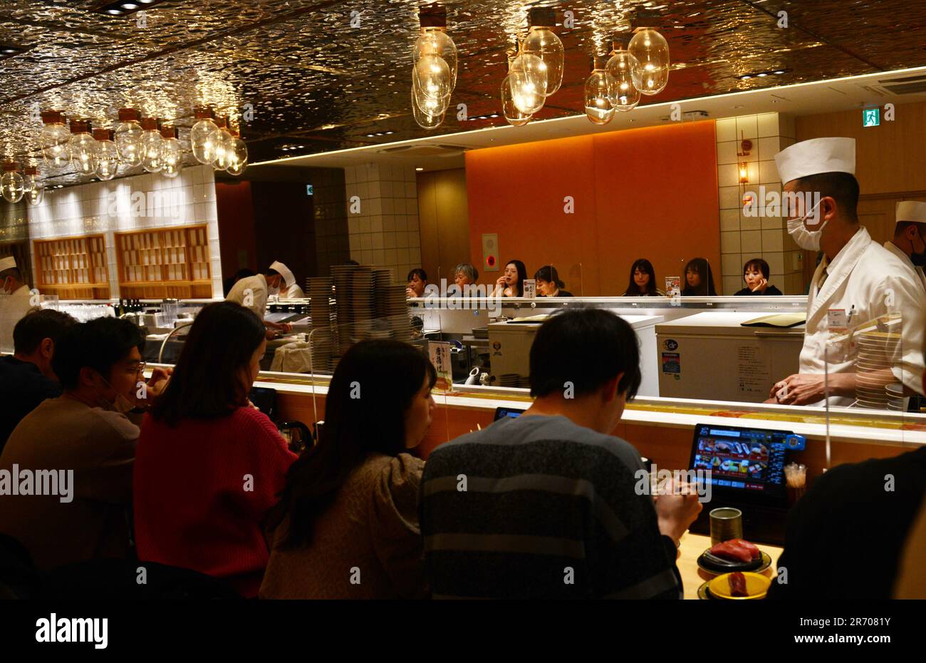 Sitting inside the Kaiten Sushi restaurant in Jingumae, Tokyo, Japan ...