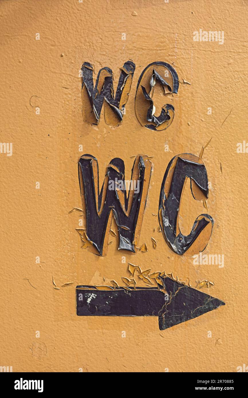 Closeup of wc text on old cracked wall paint texture background Stock ...